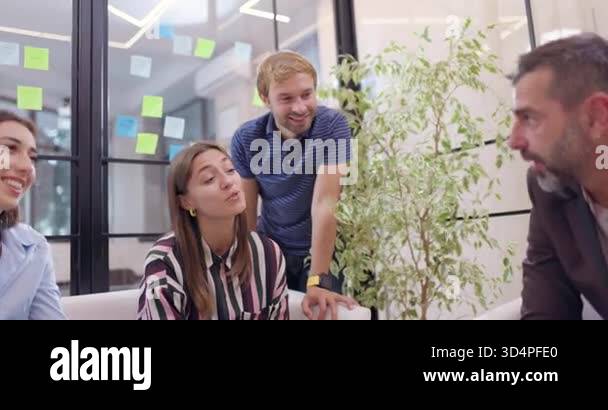 A business team celebrates success with a high five in a modern office ...