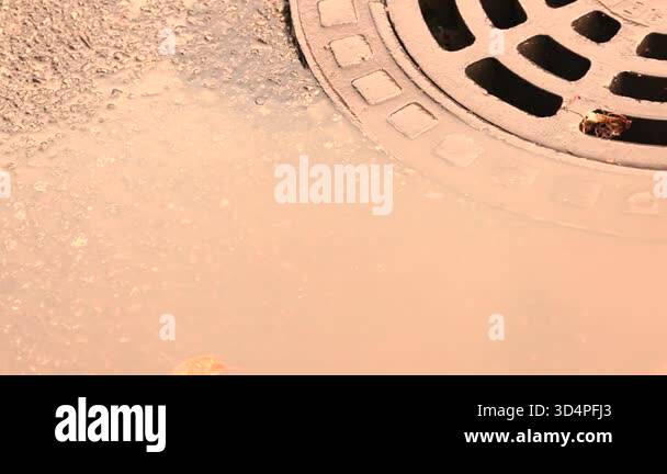 Drain manhole on city road during heavy rain urban sewage system ...