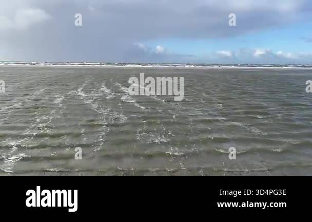 Calm waves of the North sea rolling on sandy shore at Sankt Peter ...