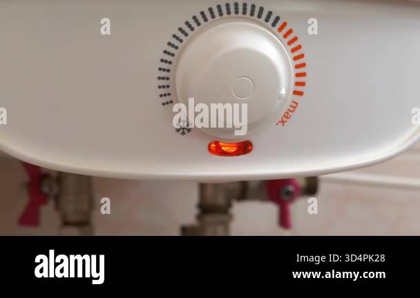 White boiler with temperature regulator of heating cold water. Red ...
