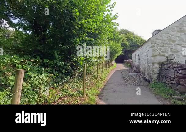 A serene path beside a white stone building Stock Video Footage - Alamy