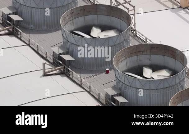 Rotating cooling tower fans on a rooftop Stock Video Footage - Alamy