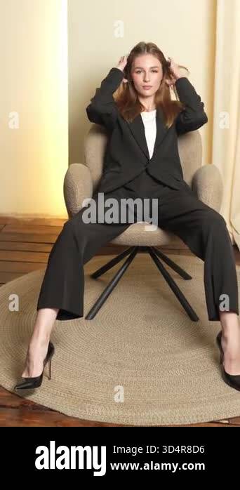 Model showcases stylish fashion in modern studio setting with relaxed ...