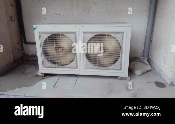 One Air conditioner unit with two big fans running appears functional ...