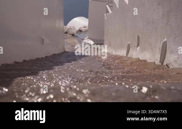 Water flowing down a stairway in santorini greece, continuous loop ...