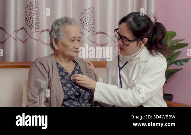 Young female doctor cares for an senior or elderly woman uses a ...