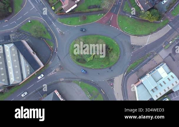 Aerial view of traffic on a roundabout with roads and cars in England ...