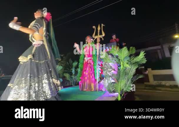 Women performing traditional dance on stage during night event Stock ...