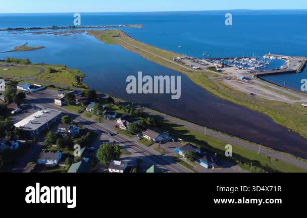 Aerial view of a small marina and its boats located on a coastal strip ...