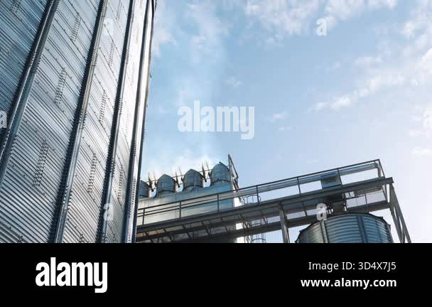 Industrial grain facility with large silos, conical tops, and metal ...