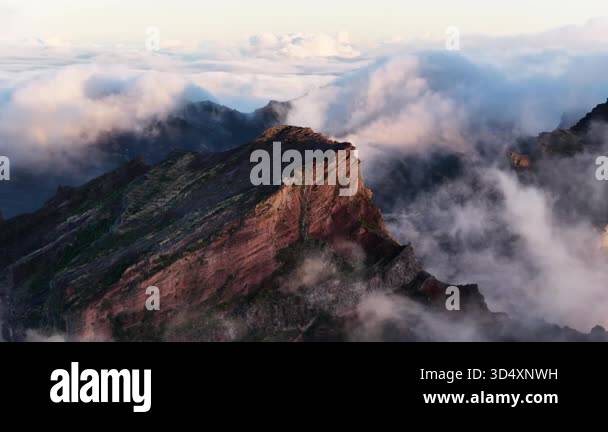 Majestic rocky mountain summits poke through the clouds in central ...