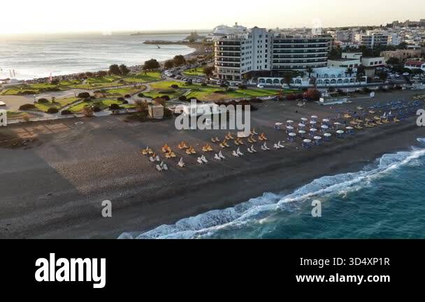 This shows a sunny day at Ixia Beach. Calm waves roll onto the shore ...