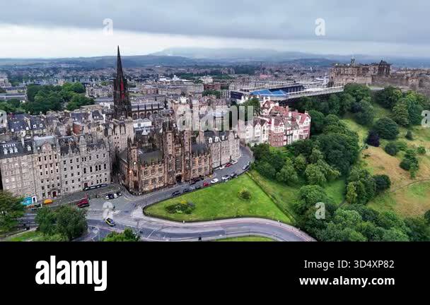 An aerial view shows Old Town Edinburgh Scotland. Buildings roads green ...