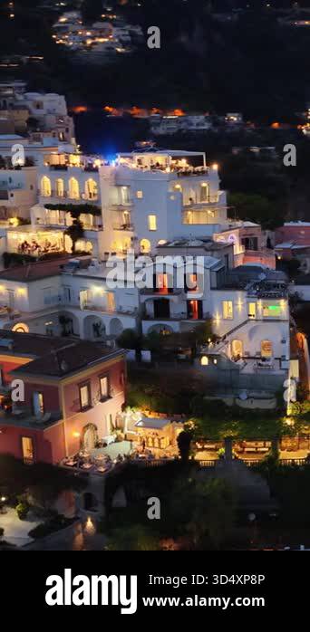A high angle captures the warm glow of lights from buildings nestled ...