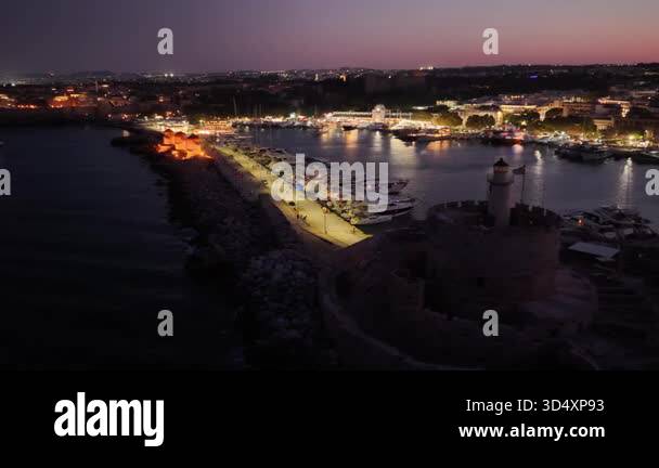 This captures the beautiful twilight hour at Mandraki Harbour in Rhodes ...