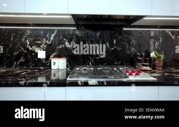 Modern kitchen interior with bight white cabinets, black marble texture ...