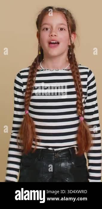 Okay. Happy young preteen child girl kid looking approvingly at camera ...