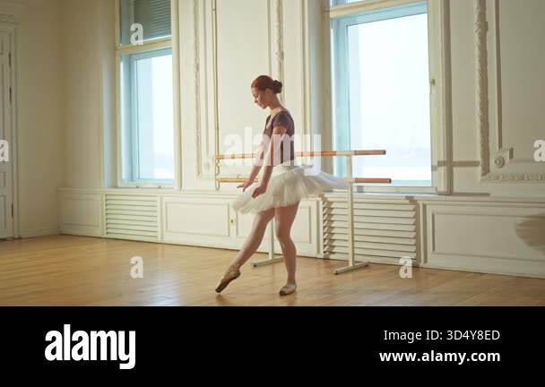 Young ballerina in tutu skirt dancing practicing ballet positions in ...
