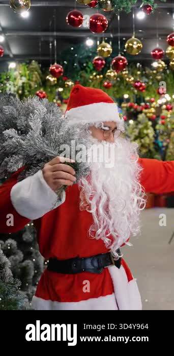 Cheerful santa claus in a traditional red suit with a white beard ...