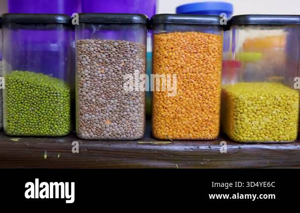 assorted indian lentils and pulses stored in transparent plastic ...