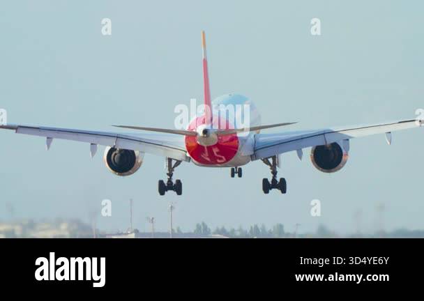 Passenger aircraft descending for landing in slow motion during daytime ...