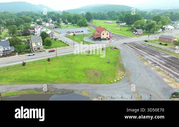 The camera captures a stunning aerial view of a small rail road town ...