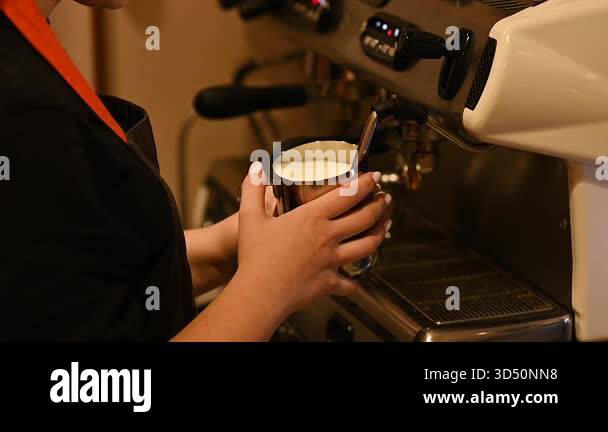 Heating milk on a coffee machine to make cappuccino or latte. The milk ...