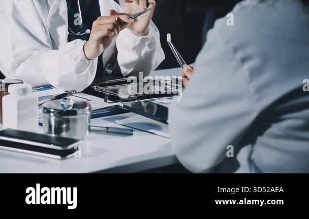 close up of a male doctor in a white coat with a stethoscope in a ...