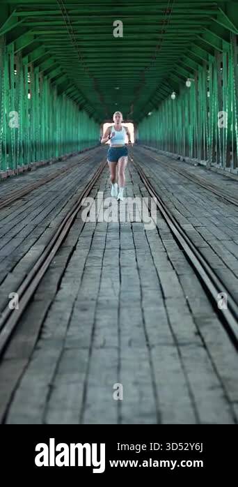 Motivation, morning jog, lens blur, sporty woman running on a bridge ...