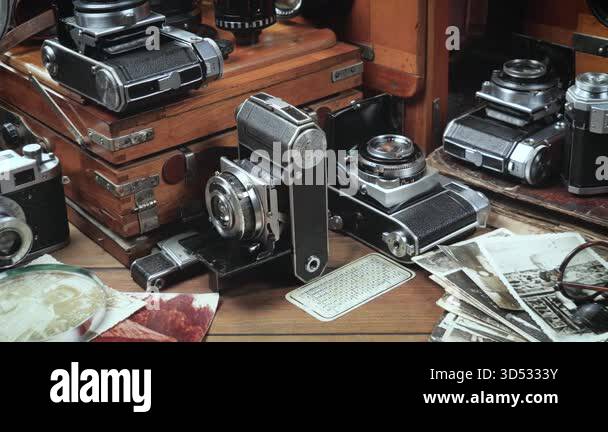 Old cameras in a composition on a wooden background, slowly moving in a ...