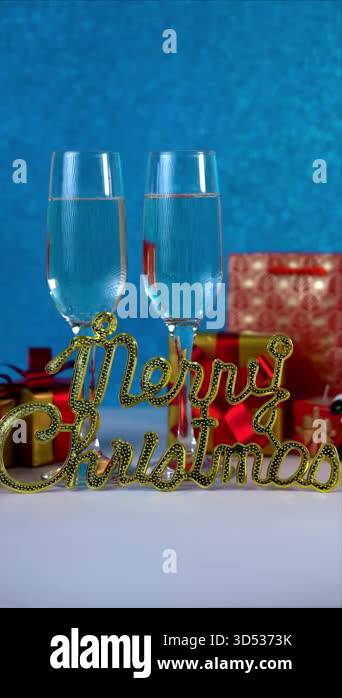 Slow cinematic zoom on elegant champagne glasses with Christmas gifts ...