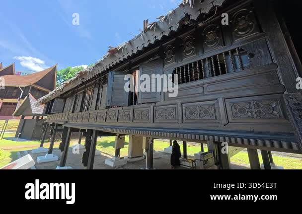Detailed hand-carved floral motifs adorn the wooden wall of a ...