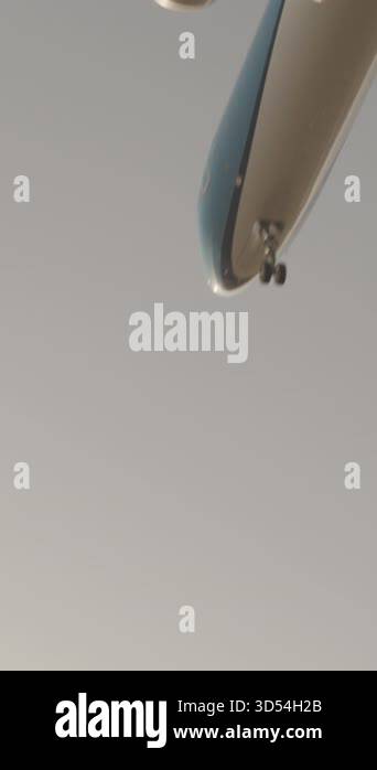 airplane flying overhead to land at airport in super slow motion at ...