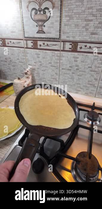 Frying pancakes in a frying pan. Talented chef cooking tasty delicious ...