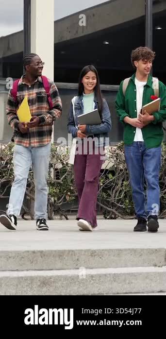 Group of multi-ethnic students walking and talking together outside ...