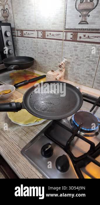Frying pancakes in a frying pan. Talented chef cooking tasty delicious ...