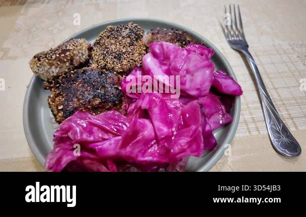 Homemade food. 4K slow motion video. Sauerkraut and cutlets. Meat and ...