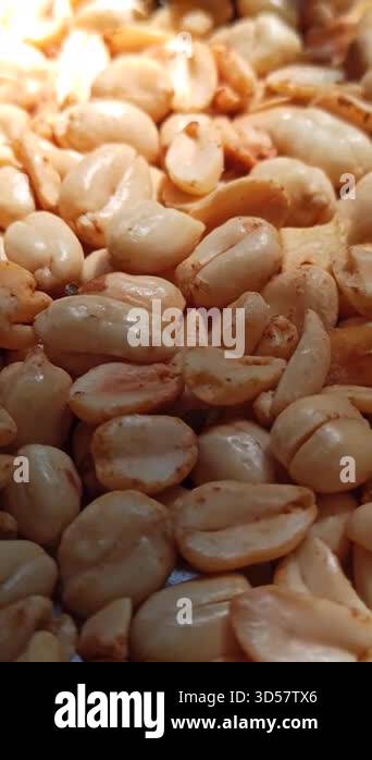 Roasted peanuts with a golden-brown color, crispy texture, and rich ...