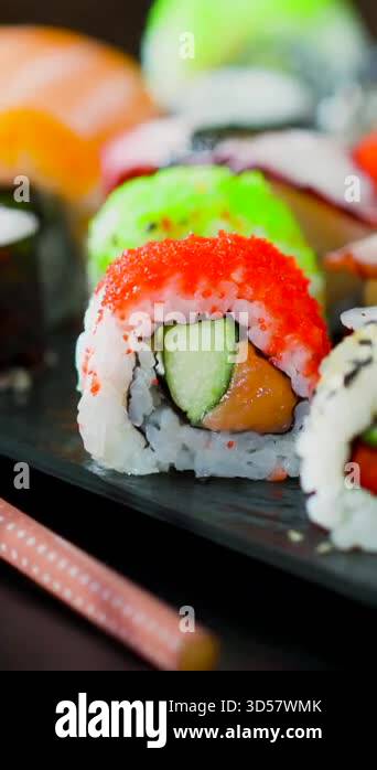 Close-up of colorful sushi rolls featuring fresh fish and vegetables ...