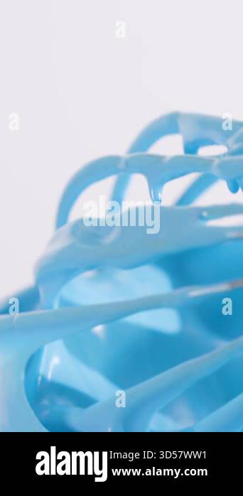 Close-up shot of whipping smooth blue cream with a mixer. Fluffy and ...