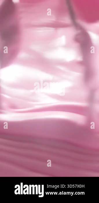 Close-up shot of whipping smooth pink cream with a mixer. Soft, fluffy ...
