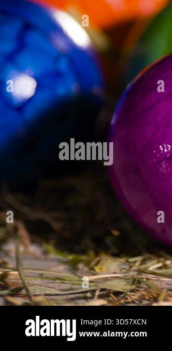 Brightly colored Easter eggs in shades of blue, purple, and green are ...