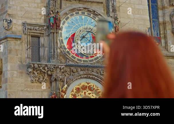 A girl takes a photo on a mobile phone Prague Astronomical Clock ...
