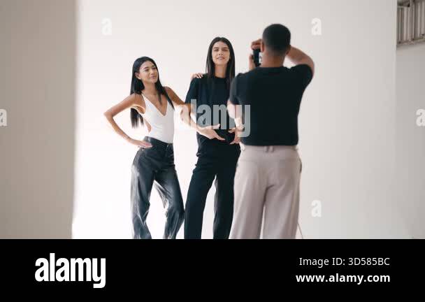 Professional photographer capturing stylized portrait session with two ...