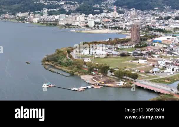 Aerial view of riverbank cityscape with buildings and greenery Stock ...
