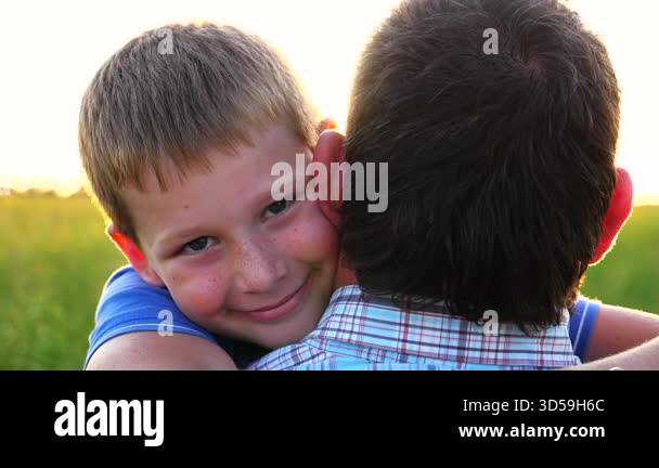 Young dad holding in hands his happy small son at countryside. Little ...