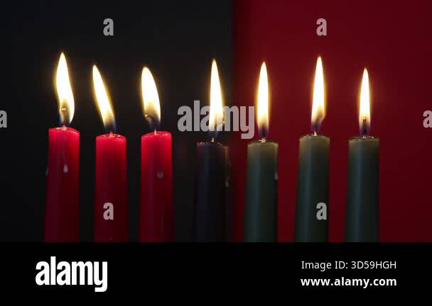 African American Kwanzaa holiday concept with traditional lit candles ...