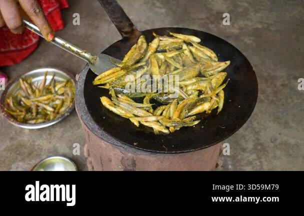 Small Snakehead or Channa orientalis Fish being fried in a pan. Fish ...
