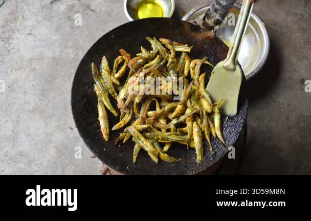 Small Snakehead or Channa orientalis Fish being fried in a pan. Fish ...