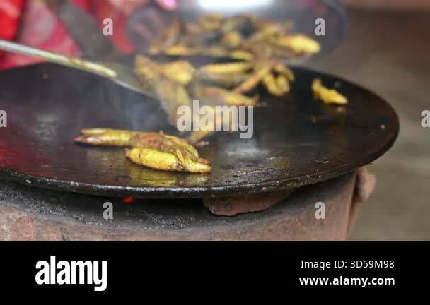 Small Snakehead or Channa orientalis Fish being fried in a pan. Fish ...